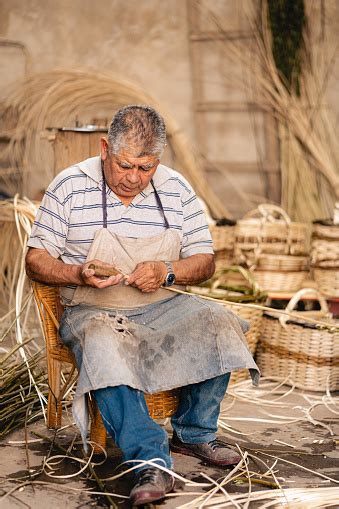 성숙한 장인이 작업장에서 고리 버들 바구니에서 작업하는 동안 숯불에 앉아 있습니다 세로 사진 라틴 아메리카 문화 예술 콘셉 60 64세에 대한 스톡 사진 및 기타 이미지