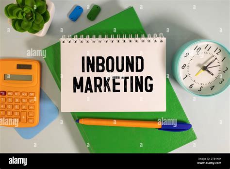 business concept notebook with text inbound marketing on pink paper with magnifier keyboard