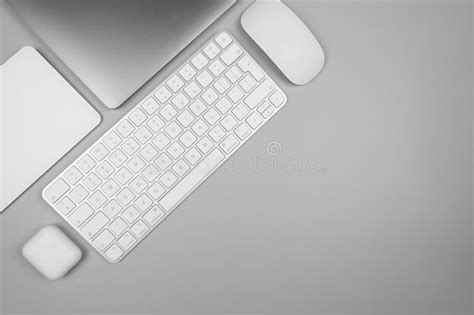 Top View Of Laptop Computer White Keyboard Touchpad Mouse And Earphones Case On Light Grey