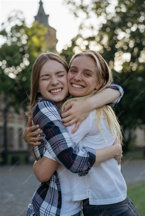Premium Photo Smiling Friends Hugging Each Other Outdoors