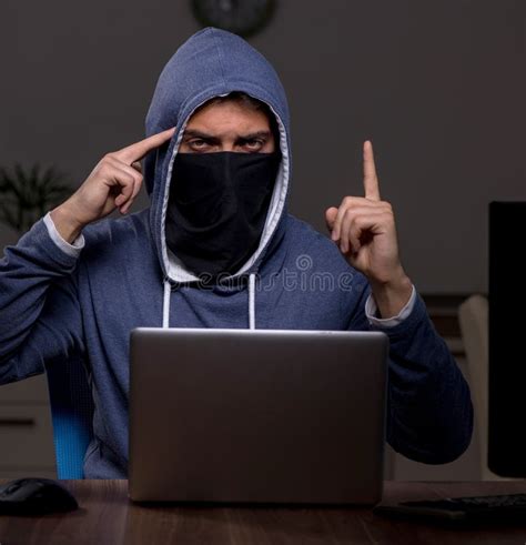 Male Hacker Hacking Security Firewall Late In Office Stock Image