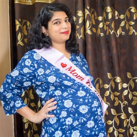 A Pregnant Indian Lady Poses For Indoor Pregnancy Shoot And Hands On