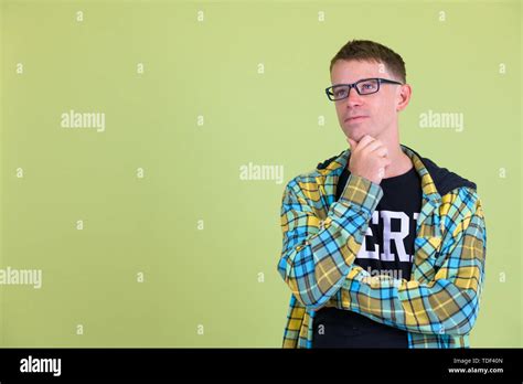 Portrait Of Nerd Man With Eyeglasses Thinking And Looking Up Stock