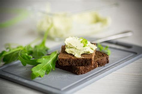 Premium Photo Bread Cheese Spread With Garlic And Arugula On Dark