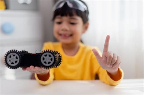 Premium Photo Asia Students Learn At Home In Coding Robot Cars And