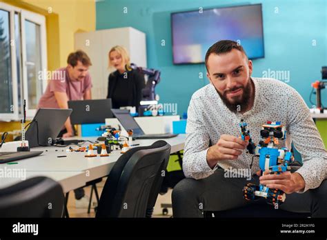 A Man Working In A Robotics Laboratory Focusing On The Intricate Fields Of Robotics And 3d
