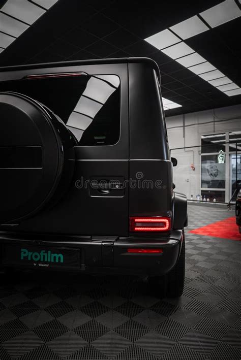 Rear View Of Matte Black Mercedes Amg G Class In Showroom Setting