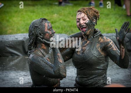 Two Women Mud Wrestling At A Mud Fighting Competition At The Lowland