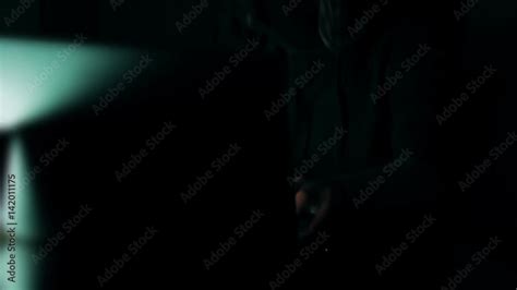 Hacker In Hood Cracking Code Using Laptop And Computers From His Dark Hacker Room Stock Video