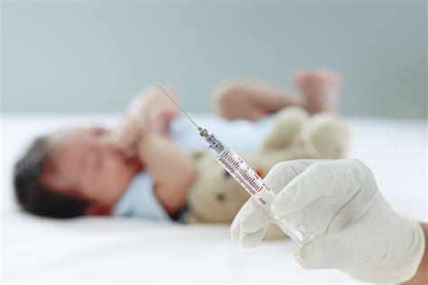 의사의 손 은 의료 장갑을 착용하고 누워 울고 아기 예방 접종 아이 백신 주사 개념을 제공 작은 신생아 아기의 흐릿한 배경으로 주사기를 들고 2명에 대한 스톡 사진 및 기타