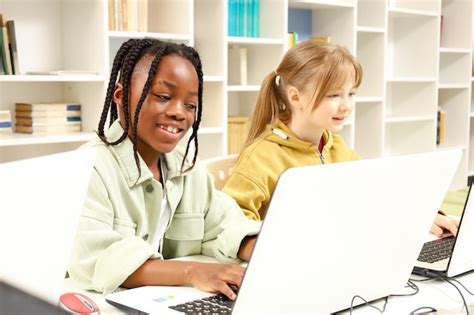 Premium Photo Happy Classmates Typing On The Laptops While Sitting Learning At Technology Class