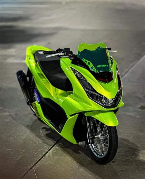 Lime Green Motorcycle Parked In A Parking Lot