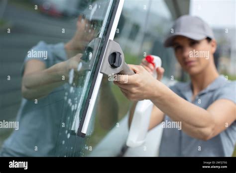 Female Cleaning Windows With Detergent Spray Stock Photo Alamy