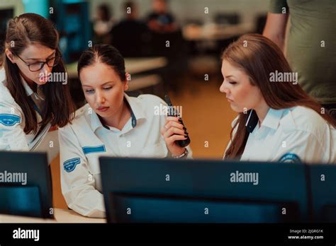 Group Of Female Security Operators Working In A Data System Control