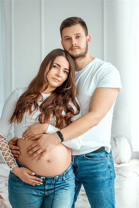 Pregnant Girl With Her Husband Lie On The Bed Beautiful Belly Of A