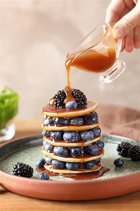 Woman Pouring Syrup Onto Tasty Pancakes Stock Image Image Of Morning