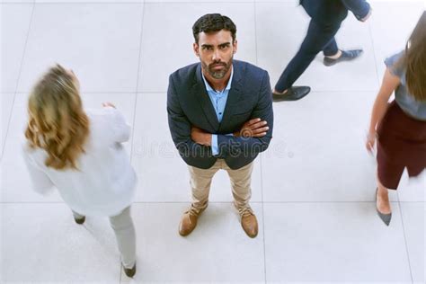 Work Hard Until You Stand Out From The Crowd Portrait Of A Businessman Standing In A Busy