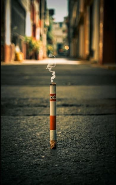 Premium Photo Close Up Of A Cigarette With Smoke Showing