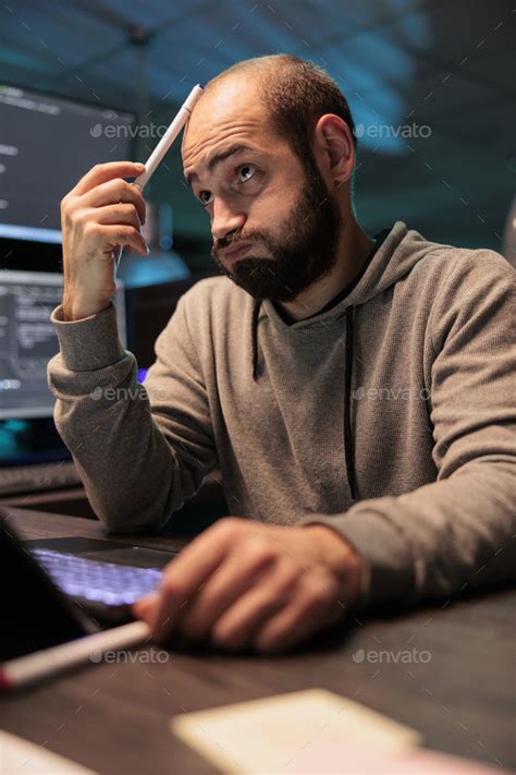thoughtful developer brainstorming ideas to find source code stock