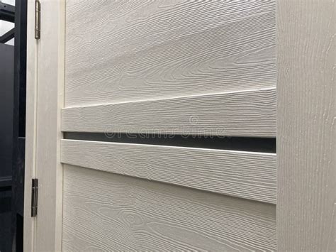 Close Up Image Of Vertical Wood Like Wall Cladding With Repeating Pattern Neutral Color Palette