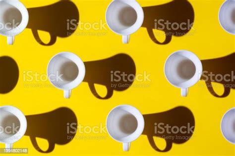 다른 컵의 실루엣으로 단단한 그림자를 드리우는 평면도에서 커피 컵의 패턴 노란색 배경 0명에 대한 스톡 사진 및 기타 이미지 0명 개념 개체 그룹 Istock