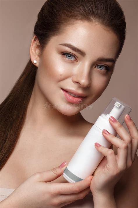 Beautiful Young Girl With Natural Nude Make Up With Cosmetic In Hands