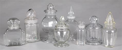 Eight Colorless Glass Candy Or Apothecary Bottles