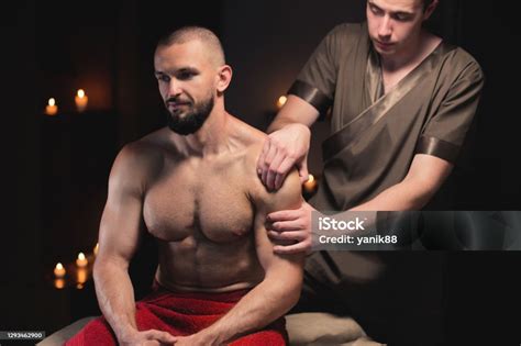 Male Shoulder And Deltoid Muscle Massage To Athlete Muscular Man In