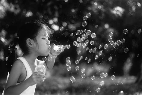 Premium Photo Girl Blowing Bubbles Outdoors