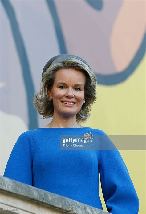 Queen Mathilde Of Belgium Poses For Photos In Front Of A Giant Poster Poses For Photos