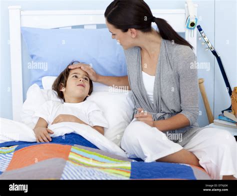 Mother Taking Her Son S Temperature Stock Photo Alamy