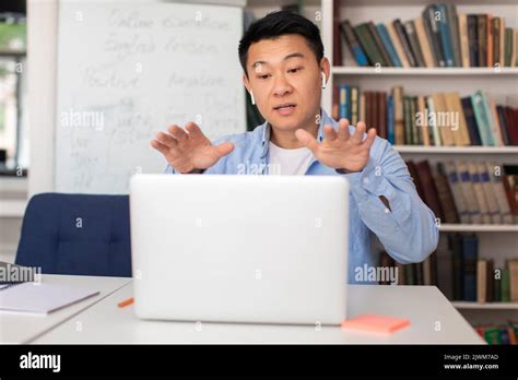Chinese E Teacher Man Talking To Laptop Having Lecture Indoor Stock