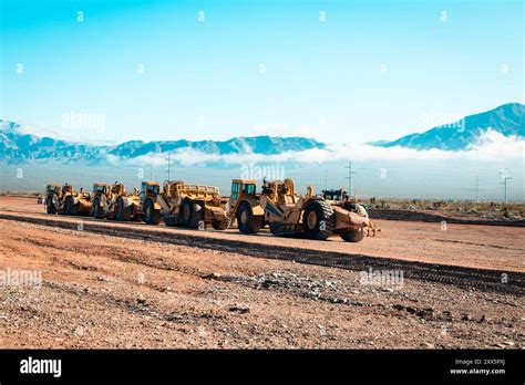 A Fleet Of Earth Movers Prepares Barren Desert Land For New Housing