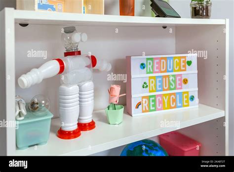 Recycled Toy Robot Made With Plastic Packages And Lightbox With Ecology