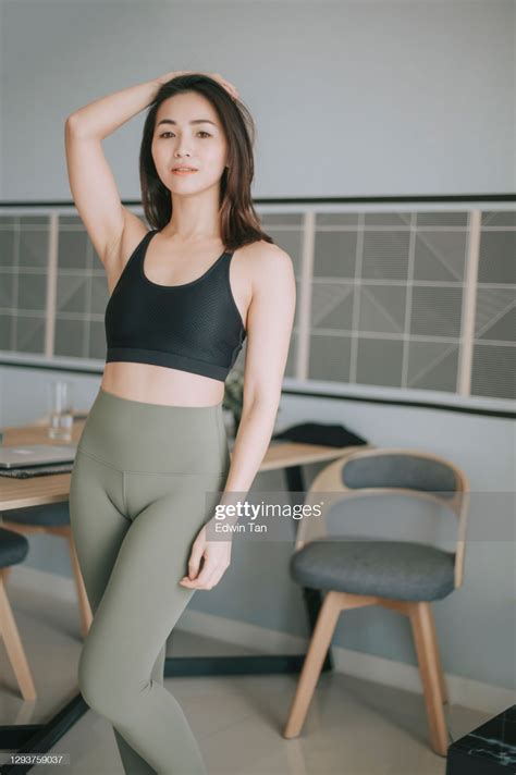 Asian Chinese Beautiful Woman With Yoga Pants And Sport Bra Beside