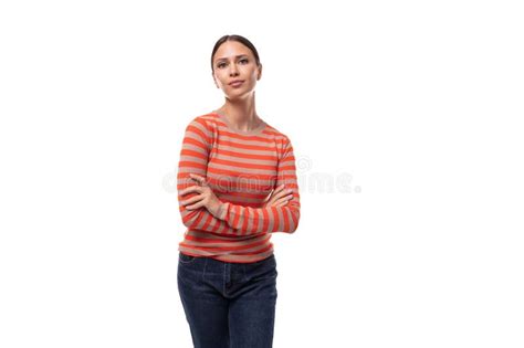 A Slender Young Brunette Woman Dressed In A Tight Fitting Orange Sweater Folded Her Hands In