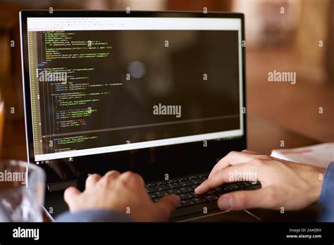 Back View Over The Shoulder Shot Of Developer Programmer With Laptop