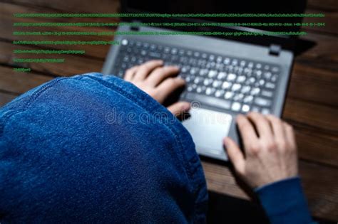 A Hacker With Laptop Sits At A Table And Abstract Binary Code Business Life Threat Virtual