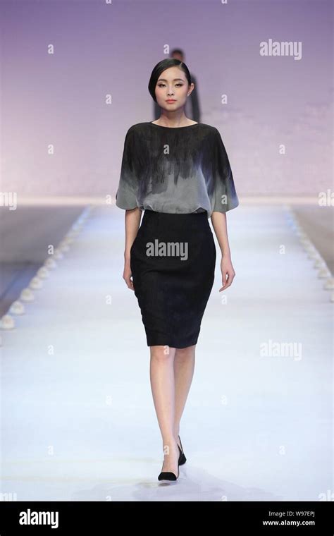 A Model Displays A New Creation By Designer Chu Yan In Her Fashion Show