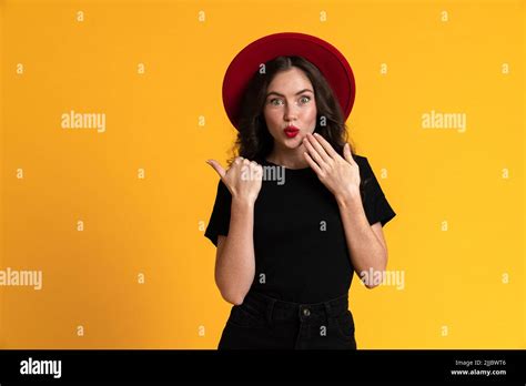 White Young Woman Expressing Surprise While Pointing Finger Aside