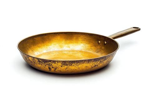 A Beautifully Crafted Golden Frying Pan Sits On A Clean Surface Its