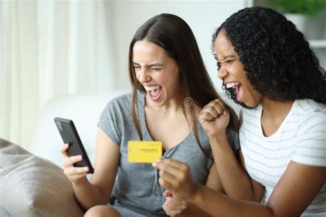 Excited Interracial Lesbian Couple Celebrating Buiyng Online Stock Photo Image Of Caucasian