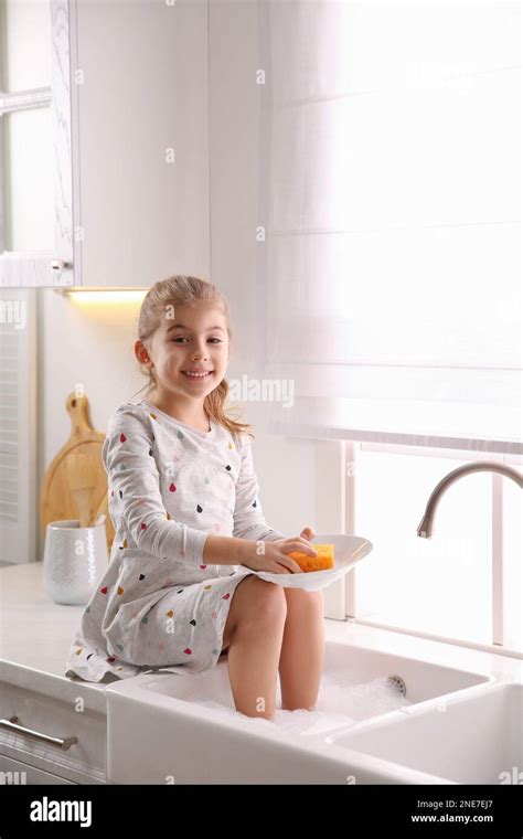 Naughty Girl Put Her Legs Into Sink While Washing Dishes In Kitchen At