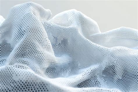 Textured White Fabric Displaying Intricate Mesh Patterns In Soft Natural Light Stock