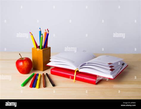 Back To School Background With Books Pencils And Apple Over Wooden