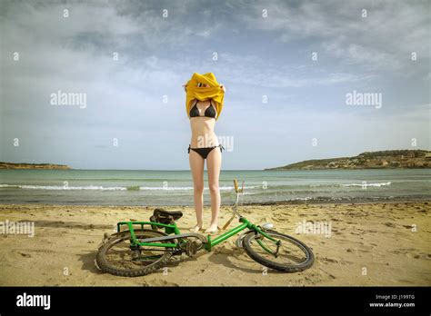 Woman Undressing On Beach Stock Photo Alamy