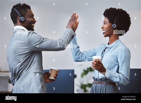 Two Happy African American Call Centre Telemarketing Agents Giving Each Other A High Five And