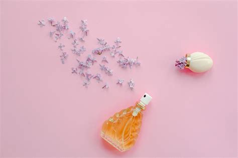핑크 바탕에 라일락 꽃의 스프레이와 향수의 세련 된 병 창의적인 최신 유행 플랫 텍스트 위한 공간을 놓으십시오 현대적인 이미지입니다 최고의 볼 수 있습니다 향수 및 꽃 향기
