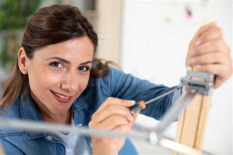 Woman Assembling Wooden Furniture Using Screwdriver Stock Image Image