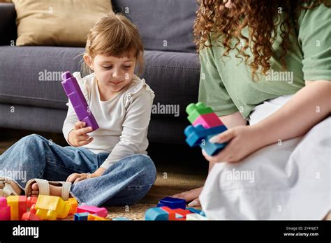 A Loving Mother And Her Babe Build Colorful Structures Together On The Floor Stock Photo Alamy